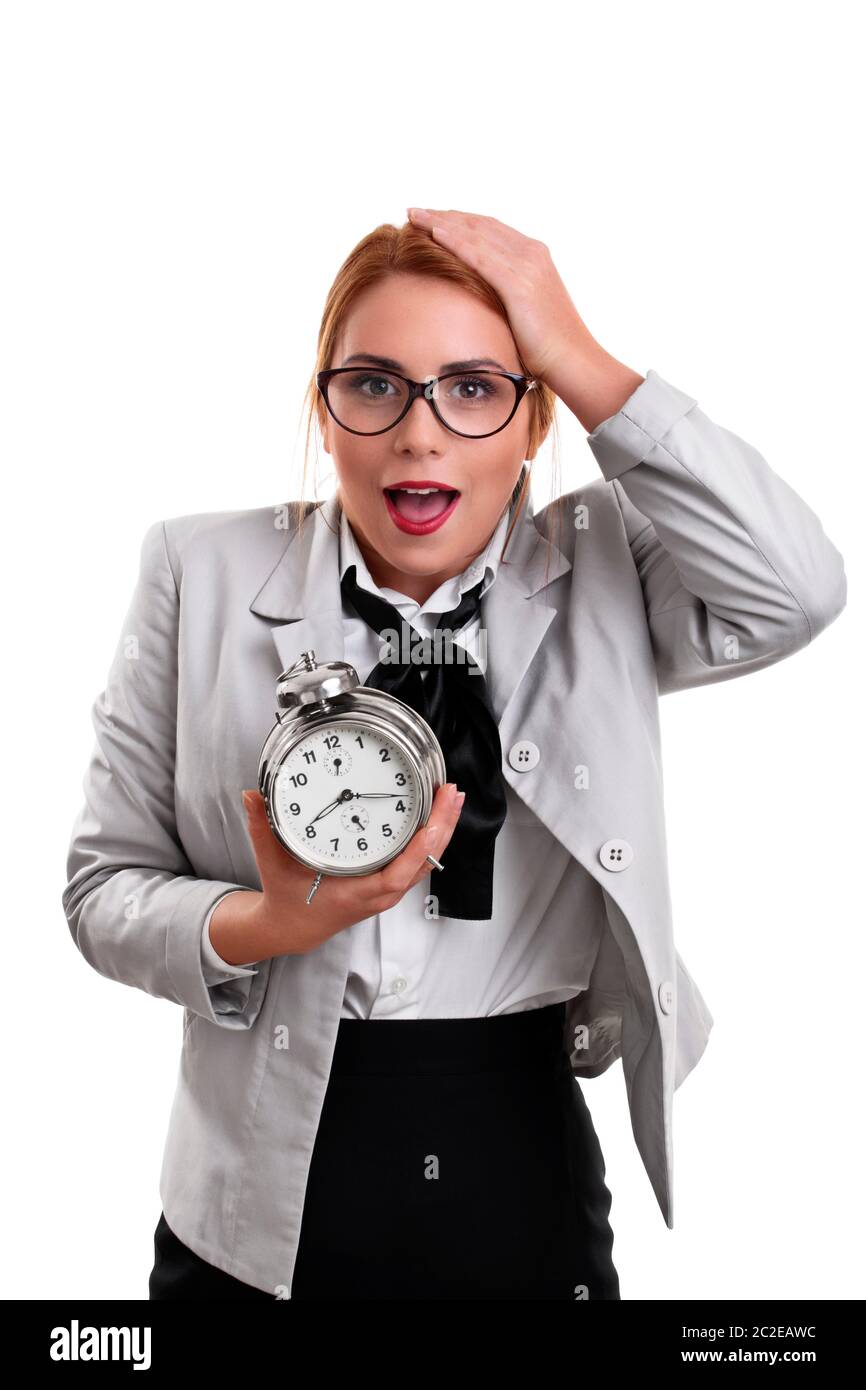 Beautiful young business woman dressed in a suit holding a clock with ...