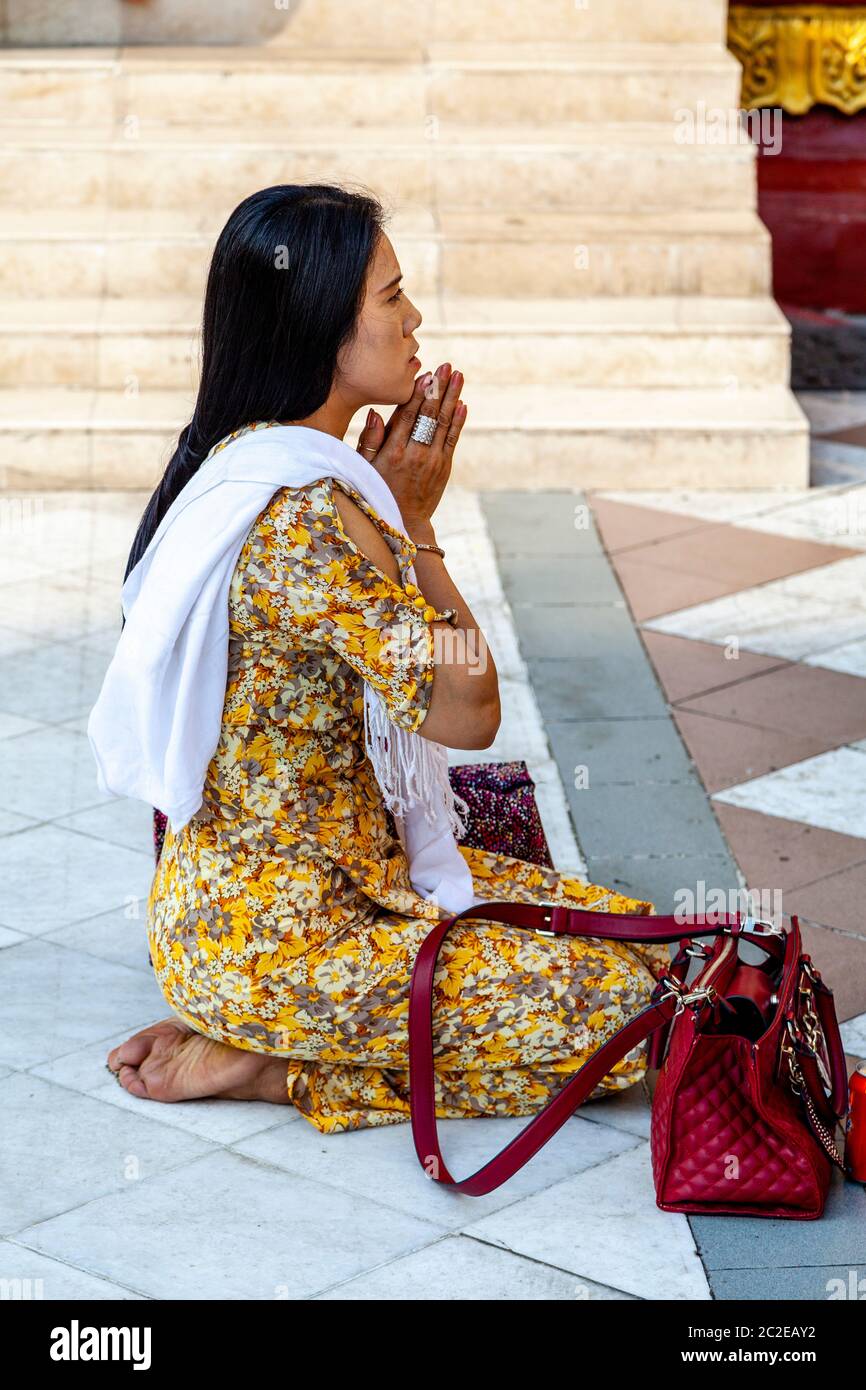 A Young Buddhist Woman Praying At The Shwedagon Pagoda, Yangon, Myanmar ...