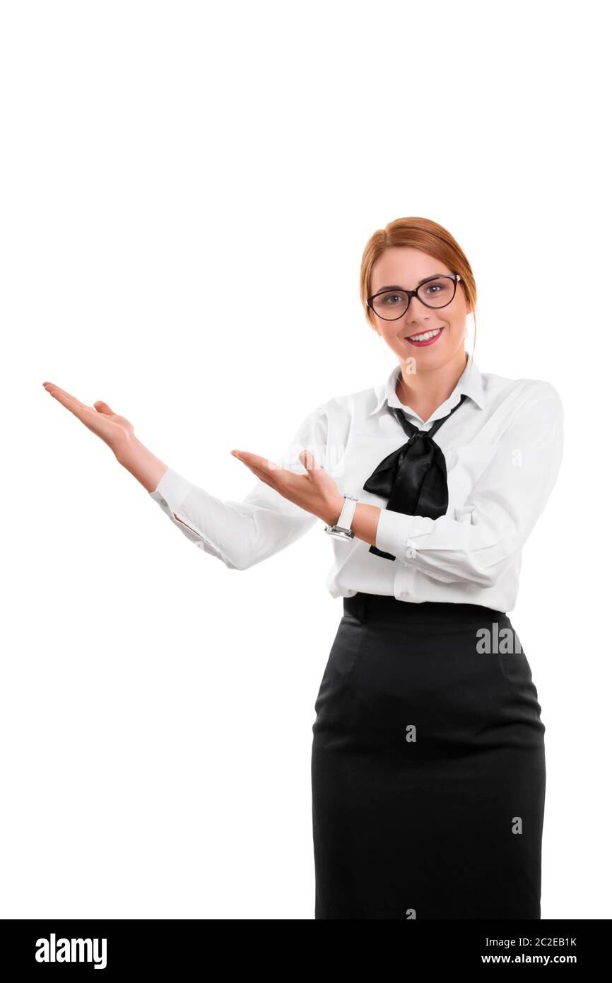 A portrait of a smiling business woman in a suit, pointing with her ...
