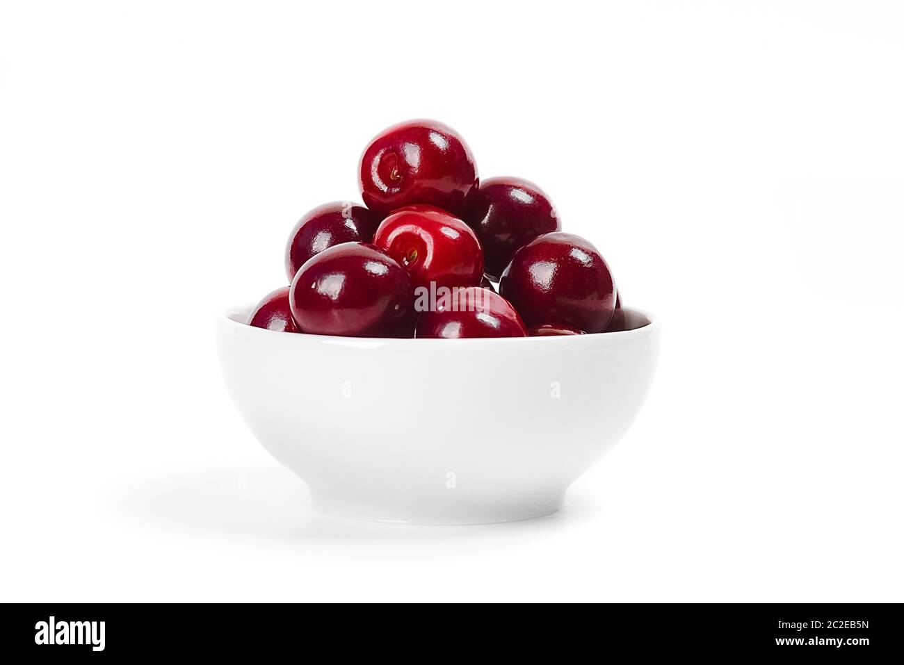 Cherries in Cup isolated on white background Stock Photo - Alamy