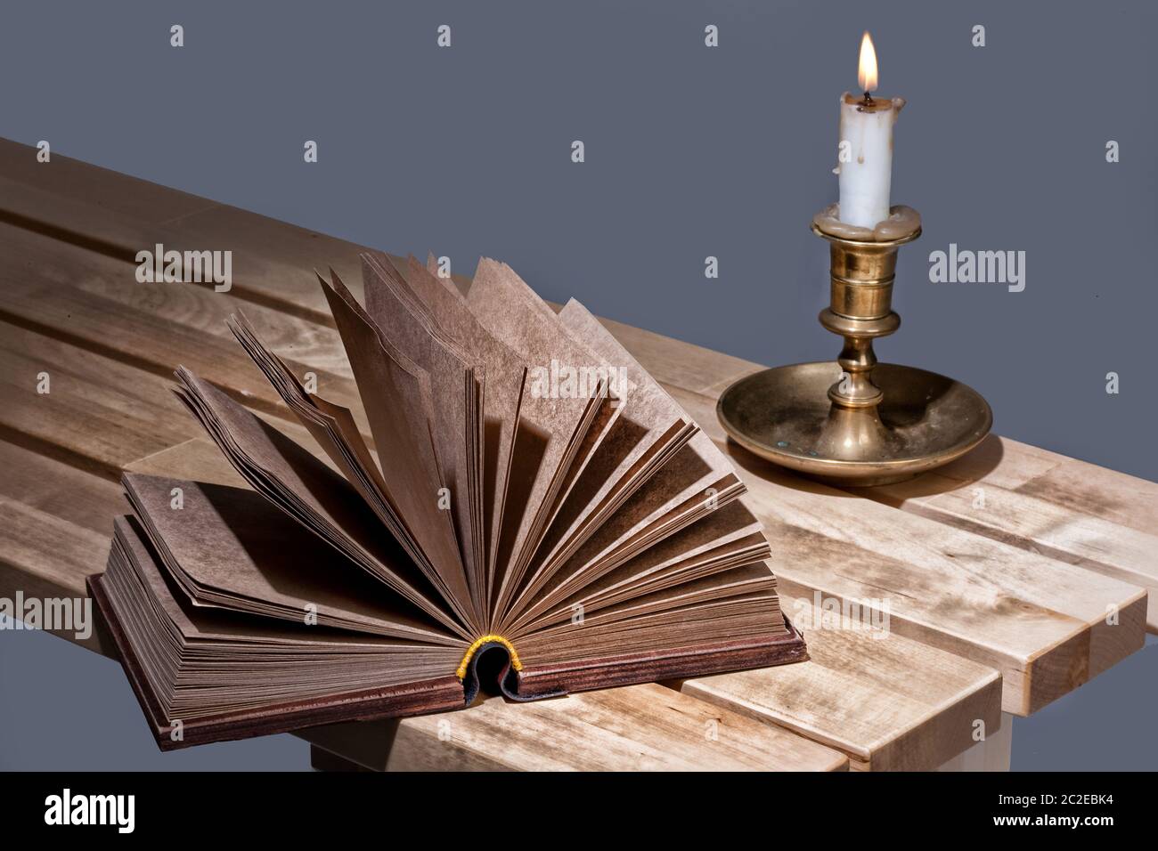 Book And Candle Stock Photo - Alamy
