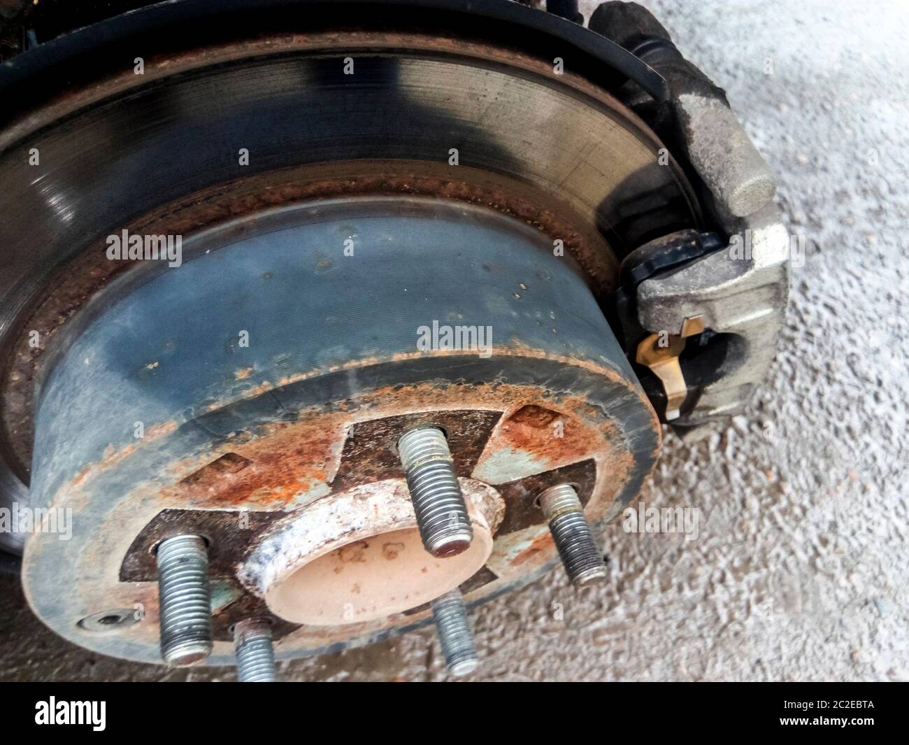 Hub with brake disc and brake shoes. The arch of the car with the ...