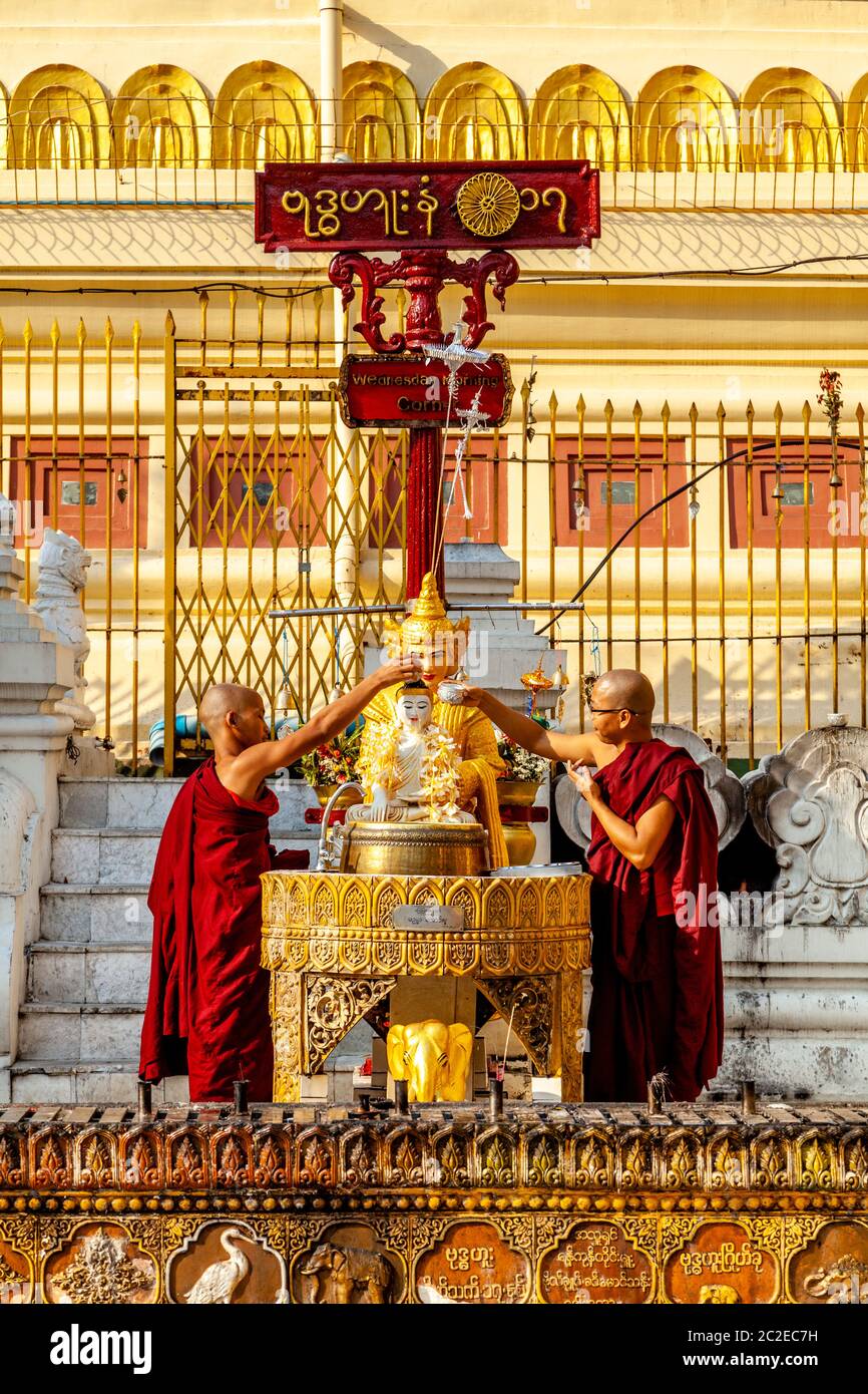 Buddhist Monks Pouring Water Over A Buddha Statue At The Shwedagon ...