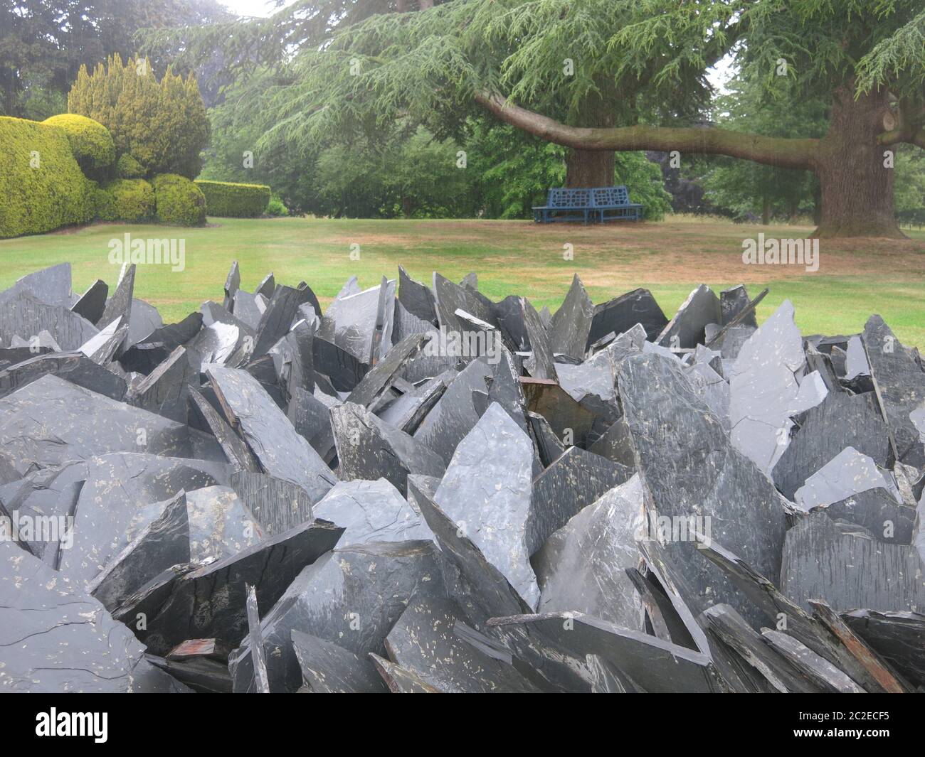 A modern art installation of sharp slabs of grey slate laid out in a ...