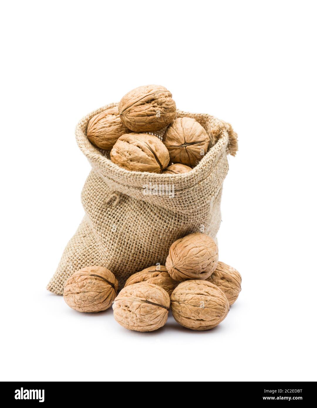 pile of walnuts in juta bag on white background Stock Photo - Alamy