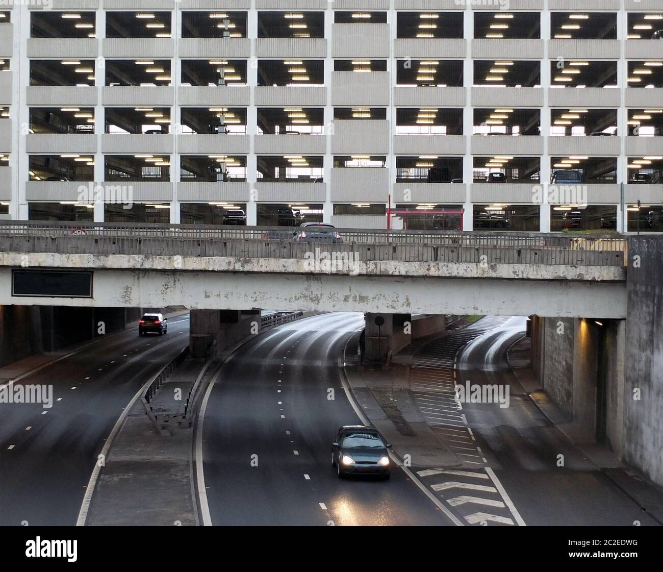 an old concrete multistory car park build over an underpass on an inner ...