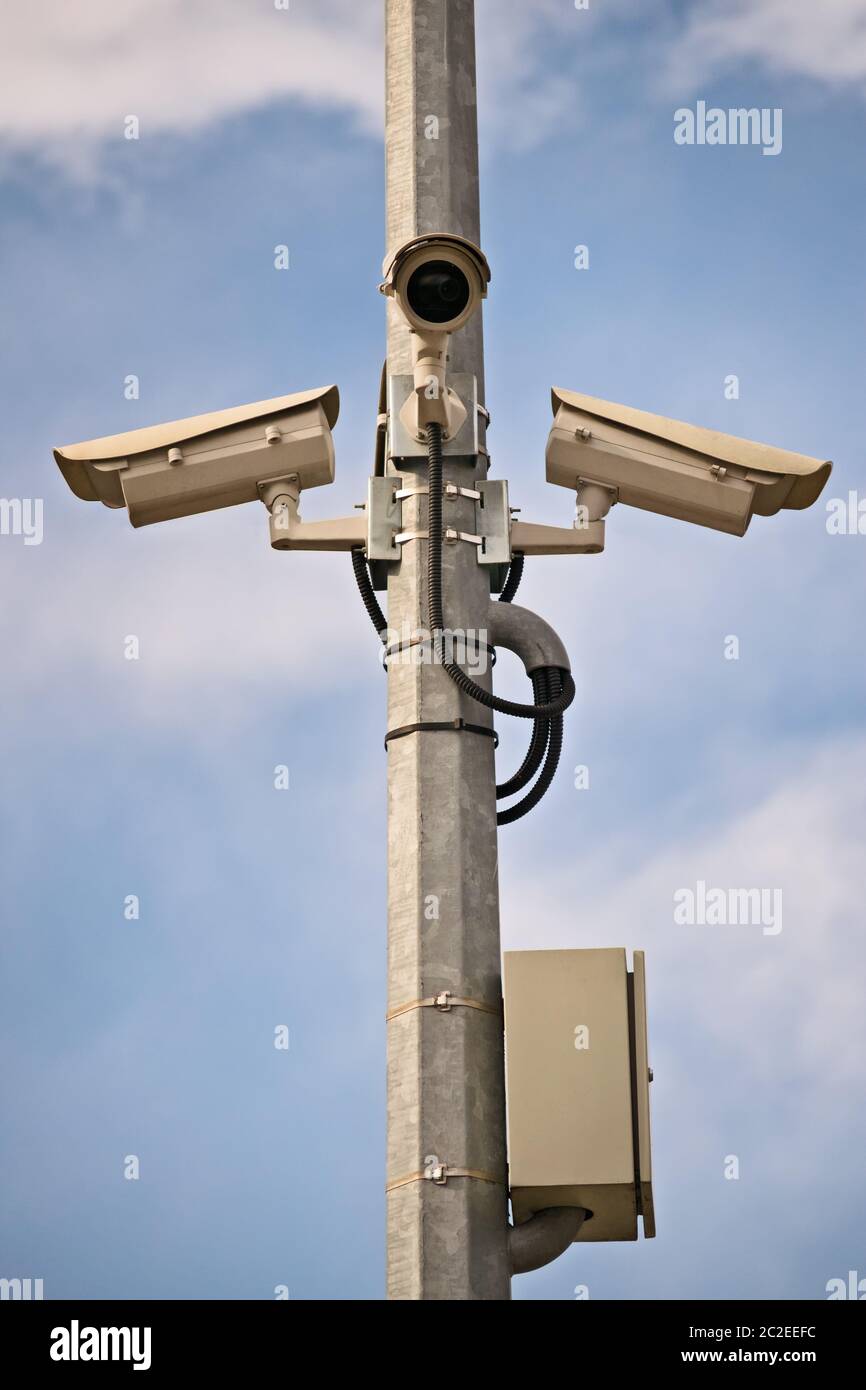 We are watching you. CCTV camera tower Stock Photo - Alamy