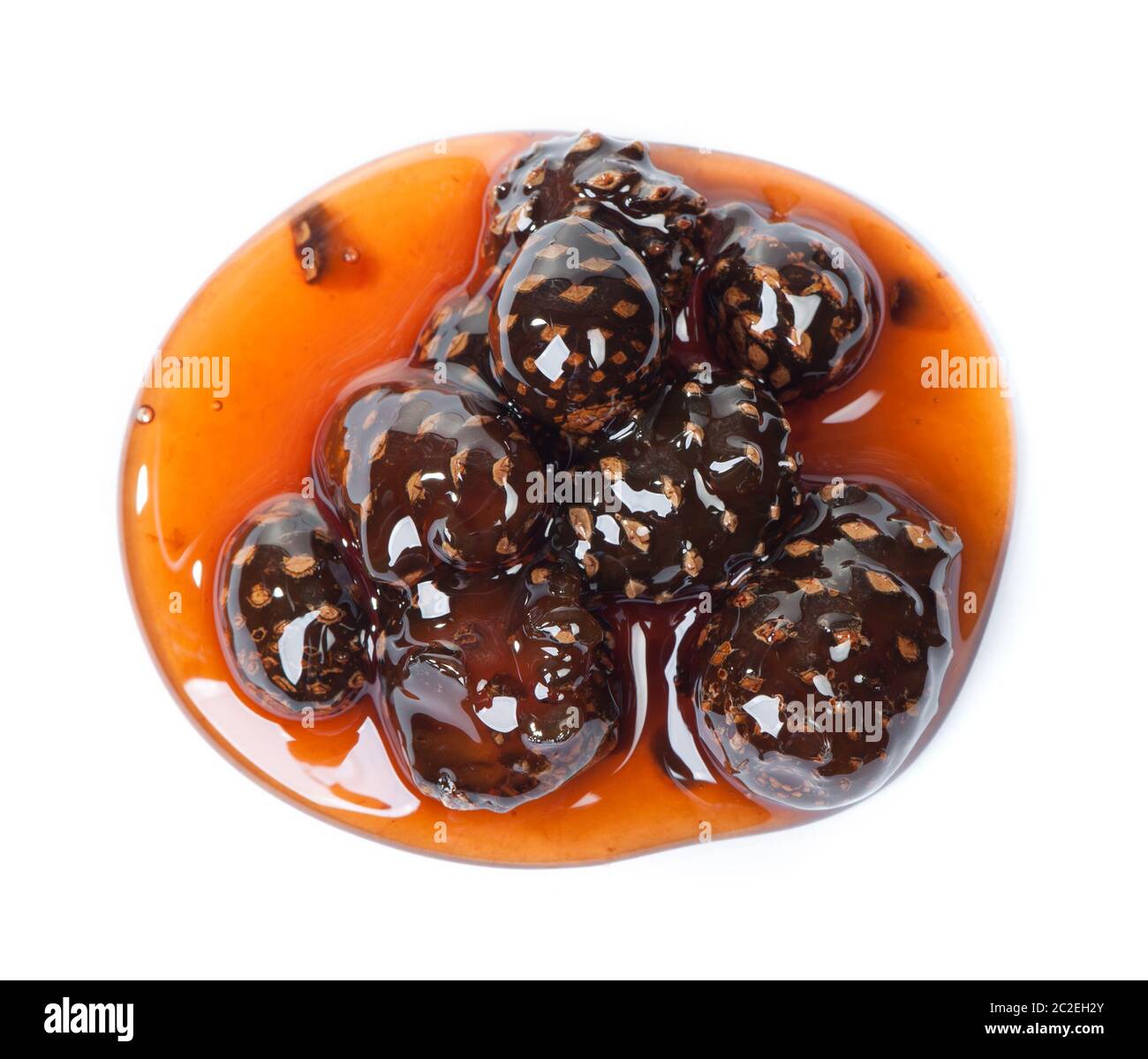 Spill of pine cone jam isolated on white background Stock Photo - Alamy