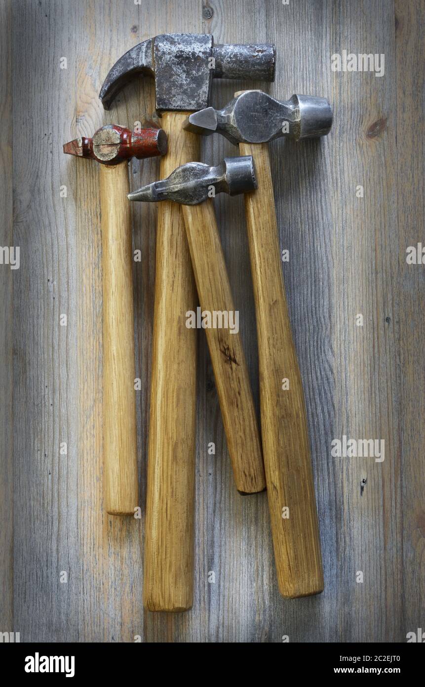 four different hammer on a wooden Stock Photo - Alamy