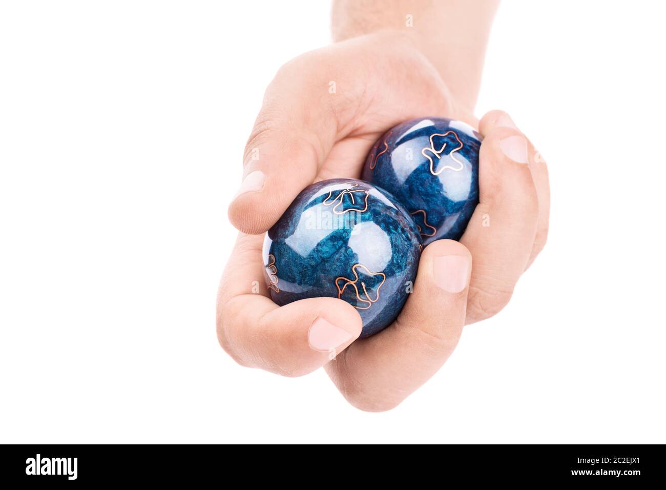 Close-up shot of a male hand holding baoding balls, isolated on white ...