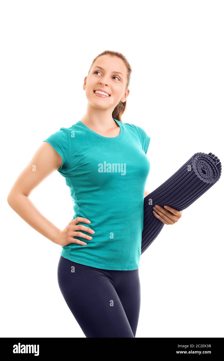Going out for a workout. Beautiful young girl holding an exercise mat ...