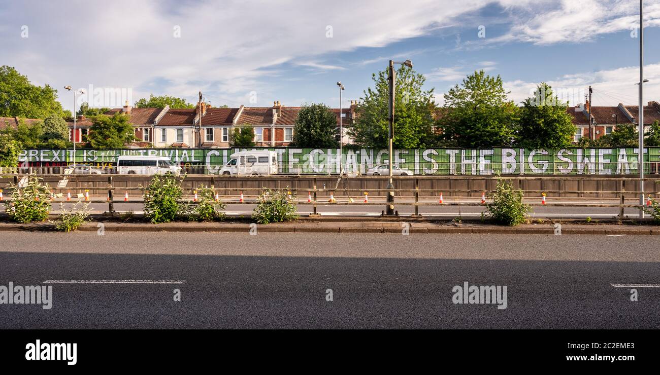 A giant climate change slogan is painted beside the M32 motorway in St ...