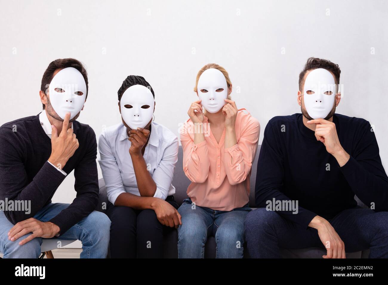 Group Of People Standing Together Covering His Face With White Masks ...