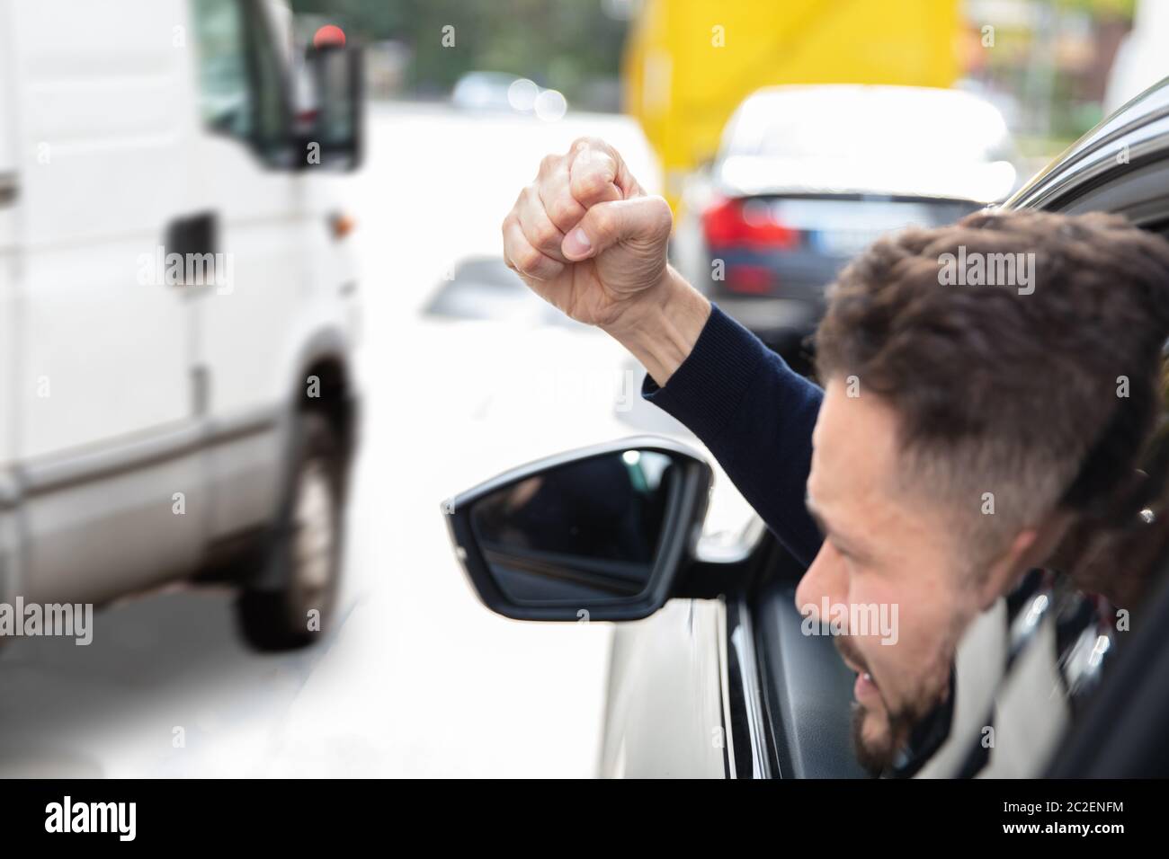 Young Man Looking Out From Car Through Window And Clenching His Fist ...