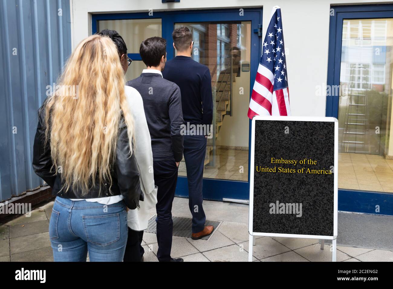 Group Of Young People Standing At The Entrance Of US Embassy Stock ...