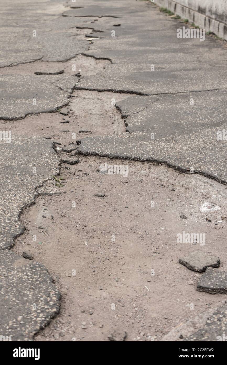 Neglected street with potholes damage shows accident traffic risk ...