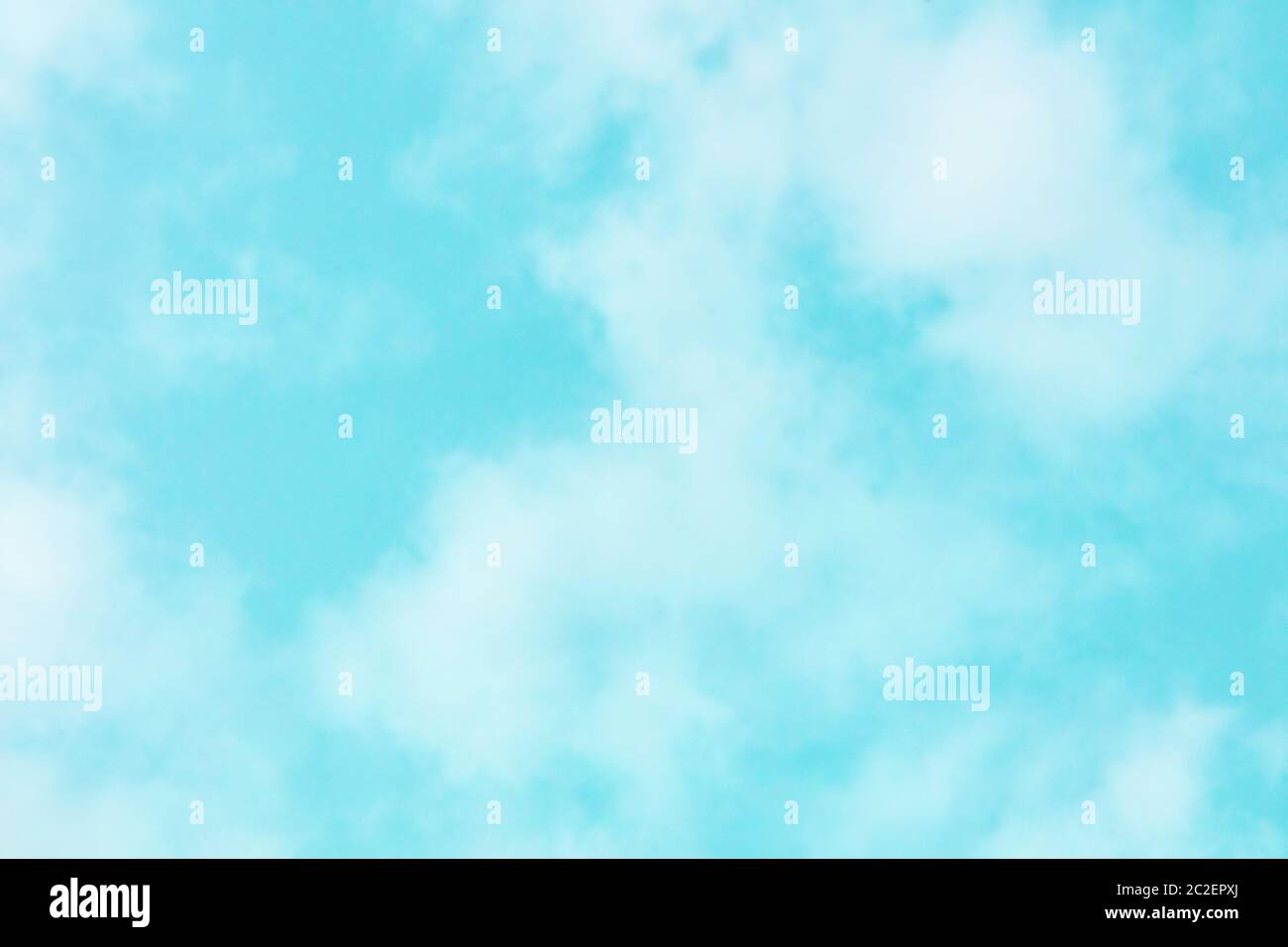 Abstract background texture of a vibrant teal blue sky with soft clouds ...