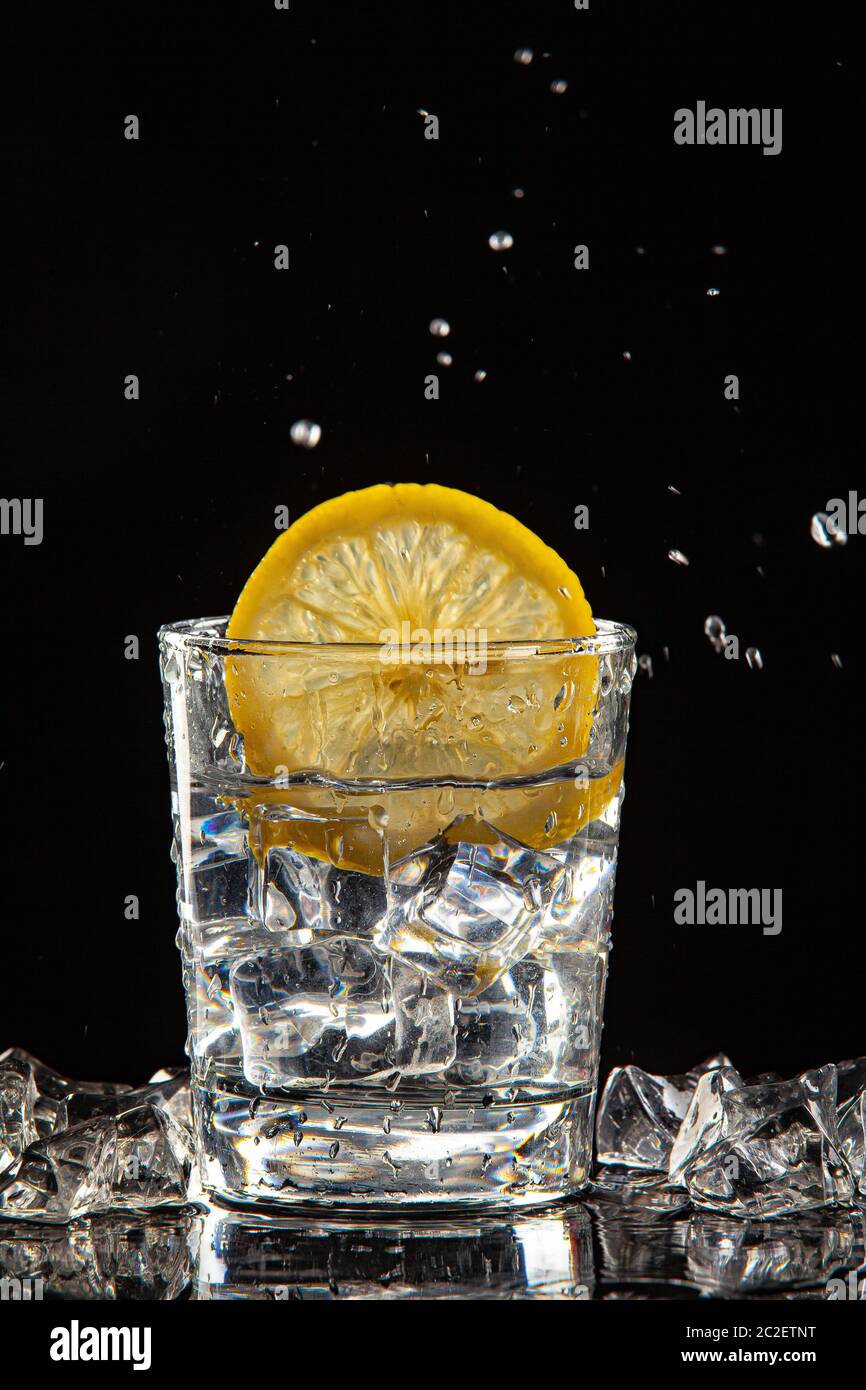 Glass Of Water, Ice And Lemon Stock Photo - Alamy