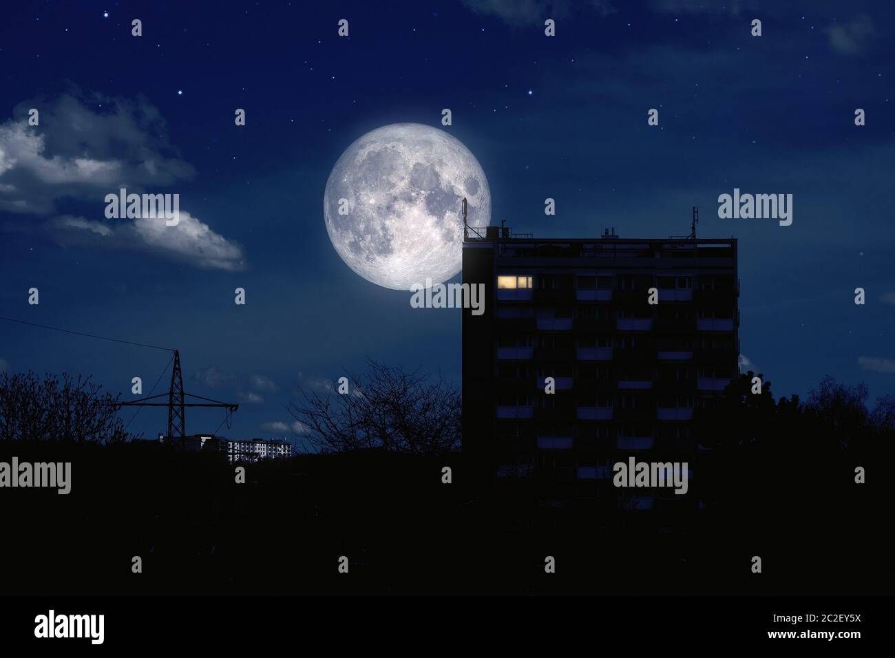full moon over a modern building Stock Photo - Alamy