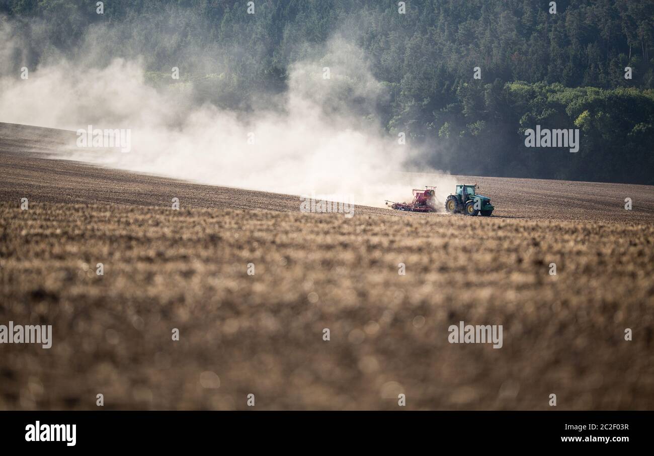 Tractor plowing a dry farm field Stock Photo - Alamy