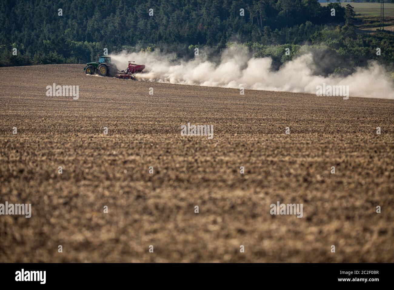 Tractor plowing a dry farm field Stock Photo - Alamy