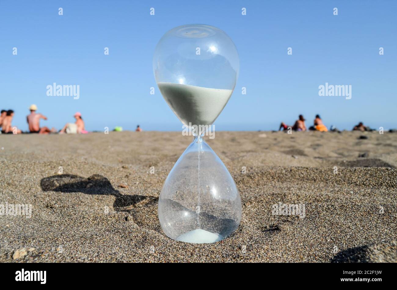 Photo Picture of Hourglass Clock on the Sand Beach Stock Photo - Alamy