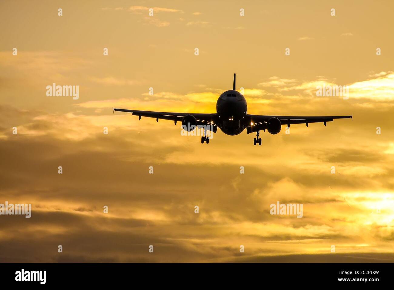 air plane in sunset sky Stock Photo - Alamy