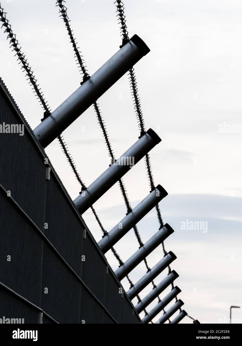 barbed wire fence. symbol of deportation and custody Stock Photo - Alamy