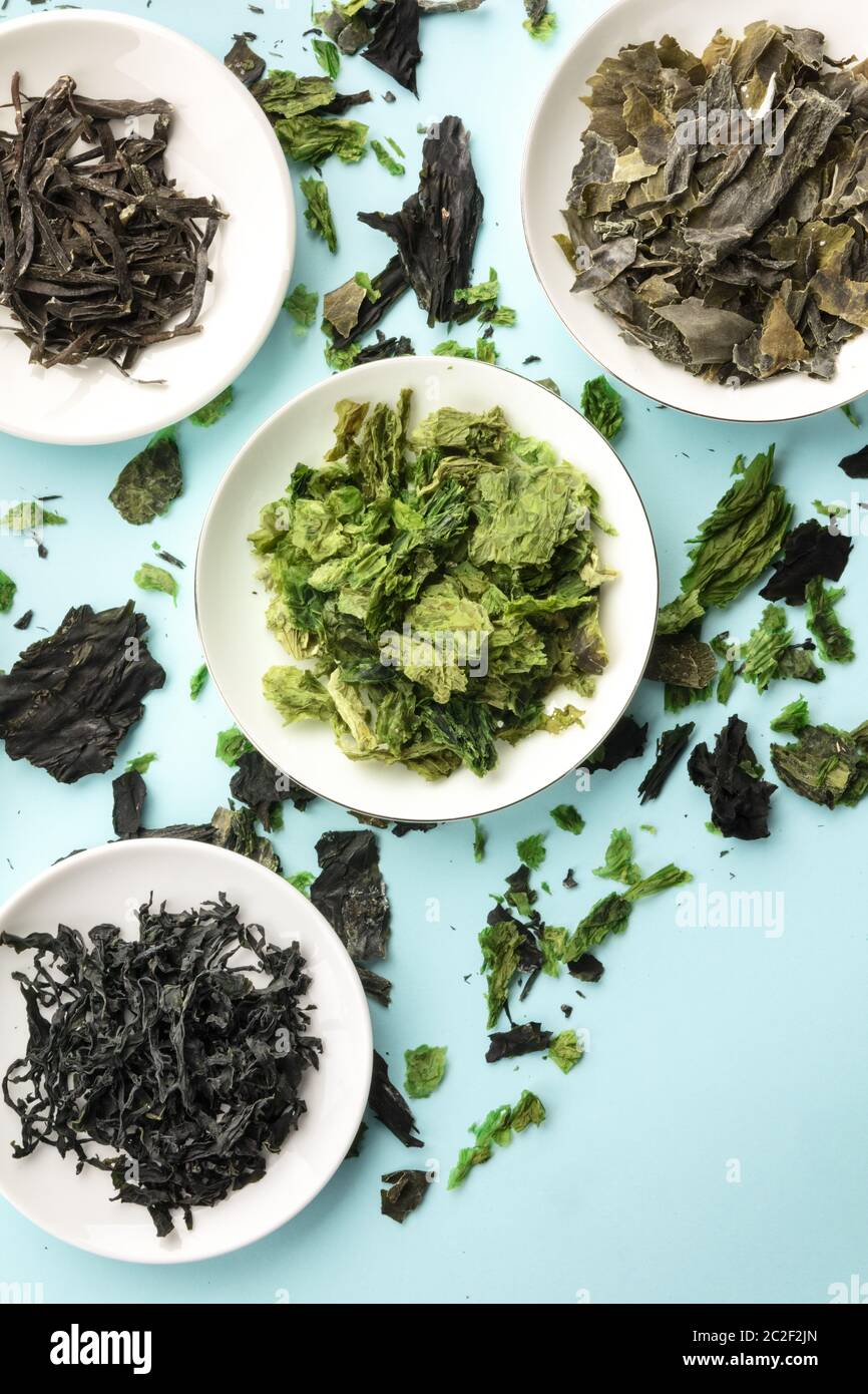 Various dry seaweed, sea vegetables, shot from the top on a blue ...