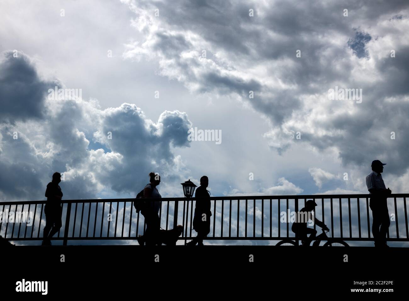 people walk across a bridge. icon image for population Stock Photo - Alamy