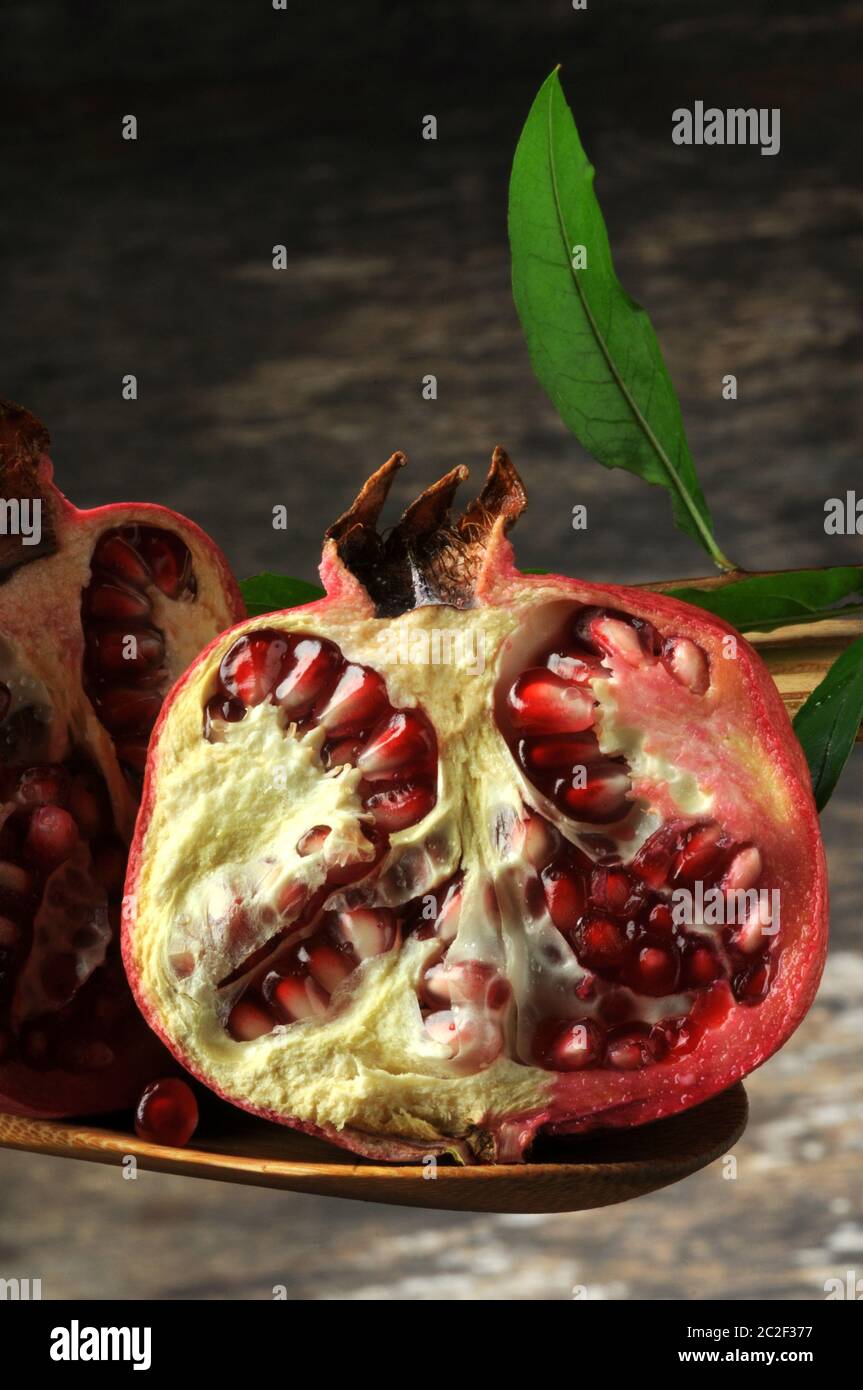 Still life of an open pomegranate Stock Photo - Alamy