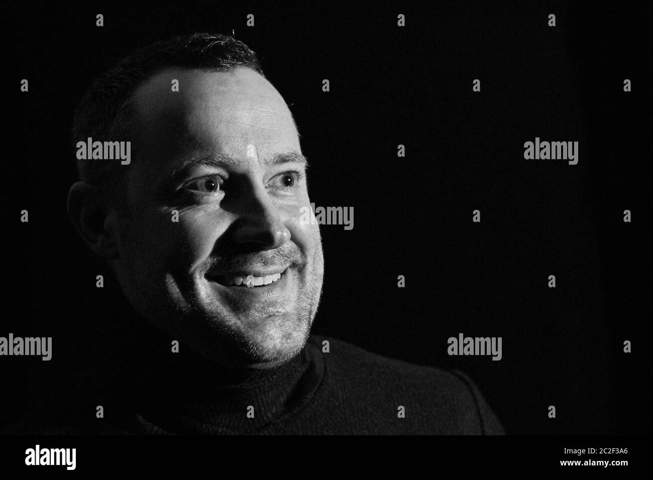 A young 30 to 45 year old man looks smiling, it looks as if he is the ...