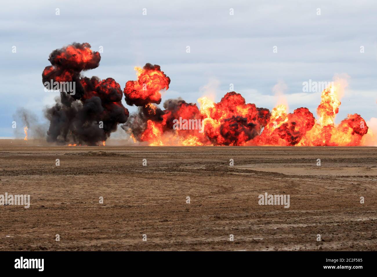 Multiple explosions on a sandy beach Stock Photo - Alamy
