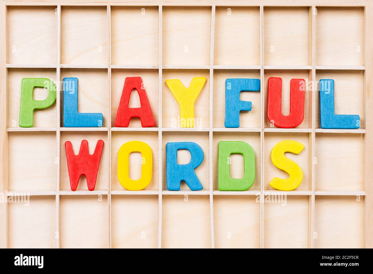 Playful words text from colorful wooden letters are on wooden ...