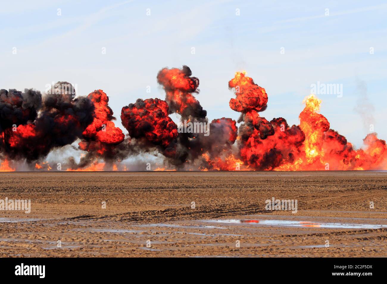 Multiple explosions on a sandy beach Stock Photo - Alamy