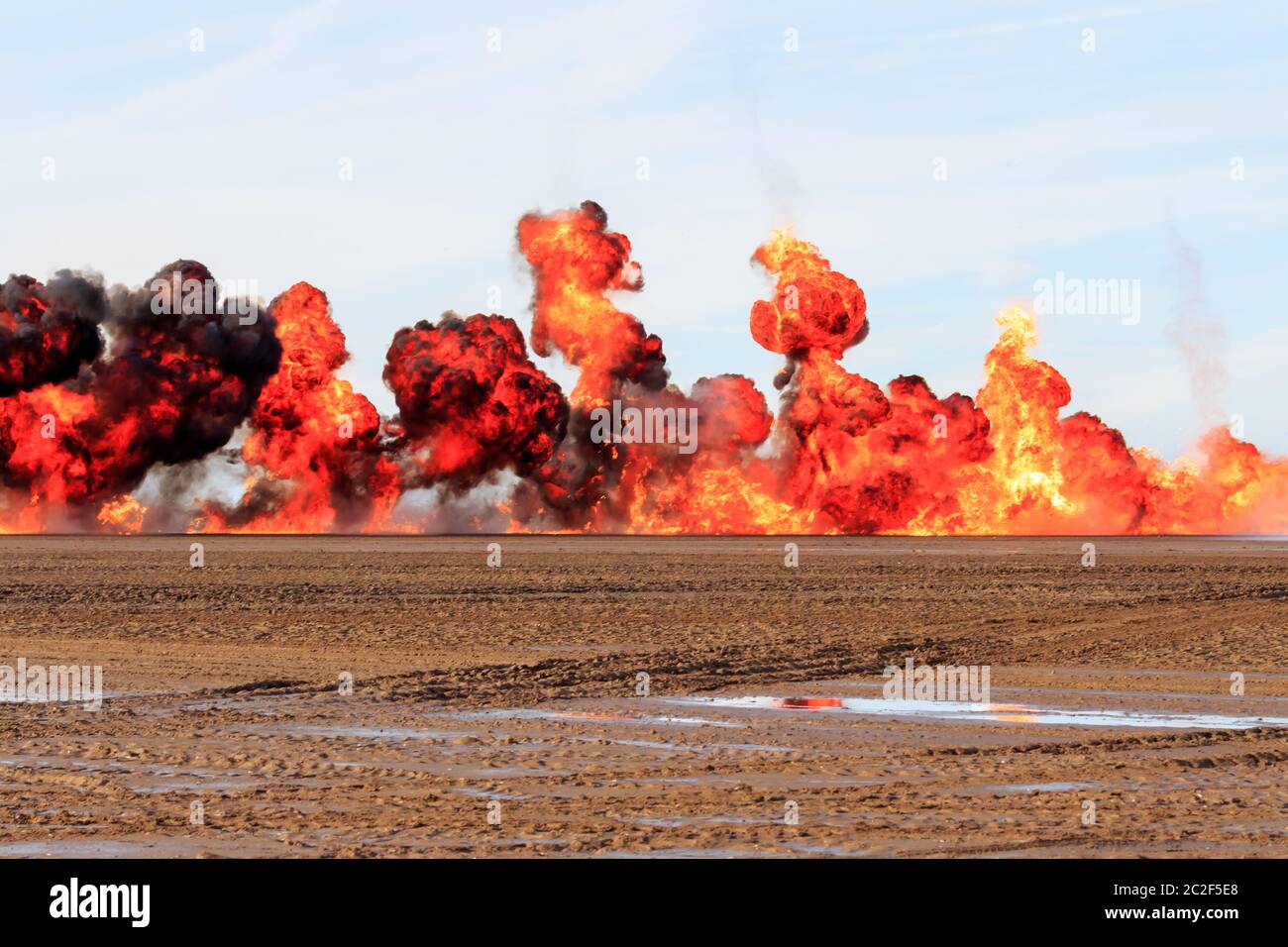 Multiple explosions on a sandy beach Stock Photo - Alamy