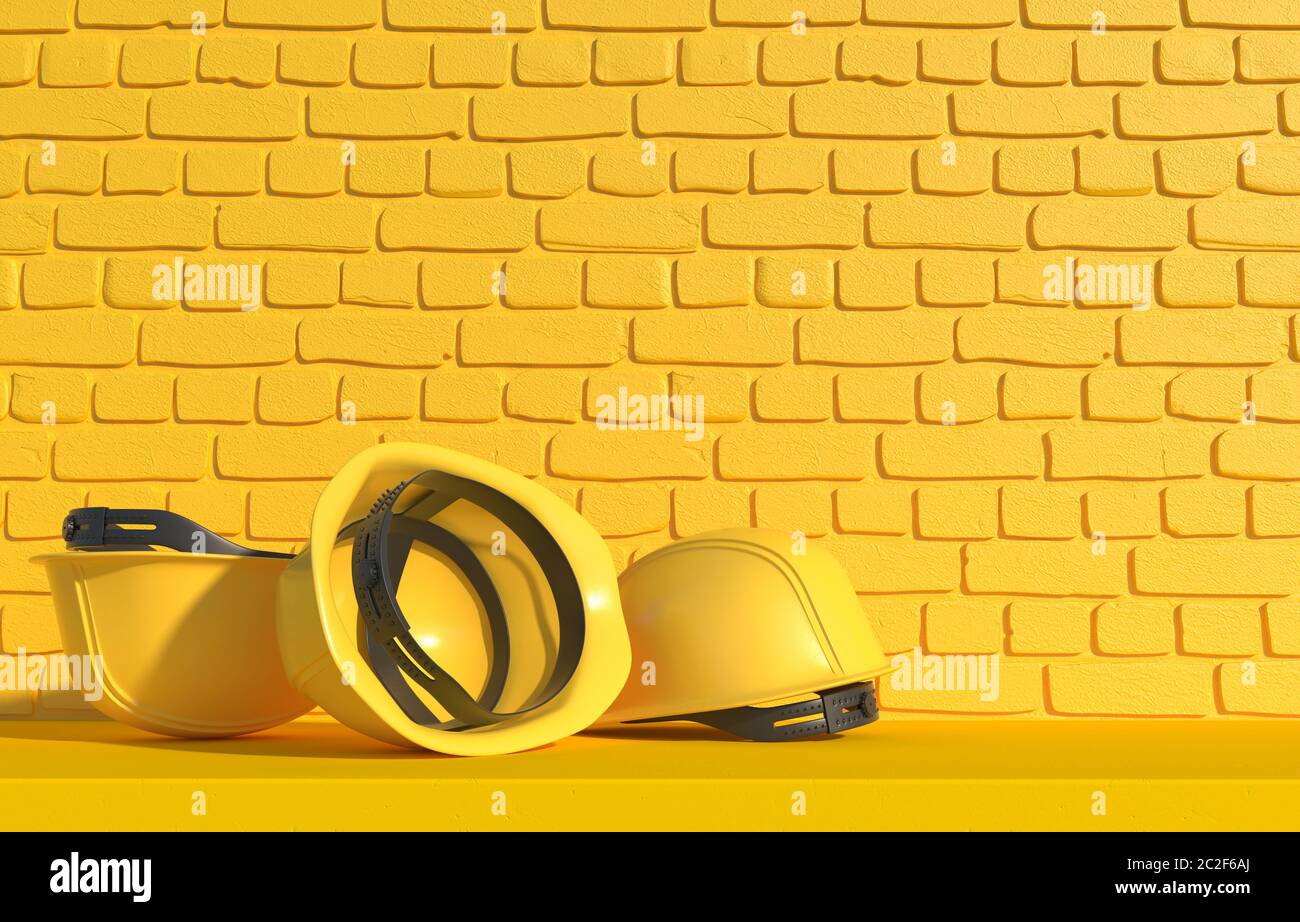 Yellow construction helmet on a background of a yellow brick wall ...