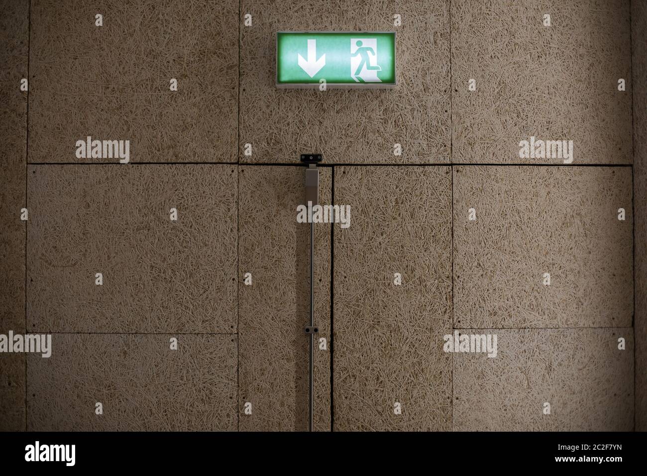 Color image of a green exit sign above a door Stock Photo - Alamy