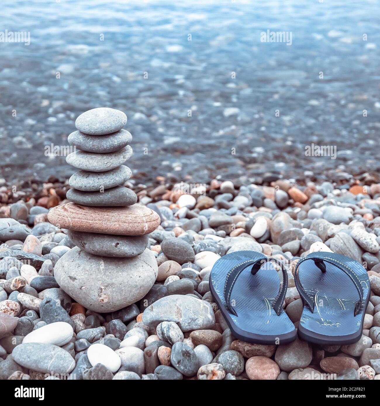 Pyramid of sea stones on pebbles of the sea shore. Seascape. The ...