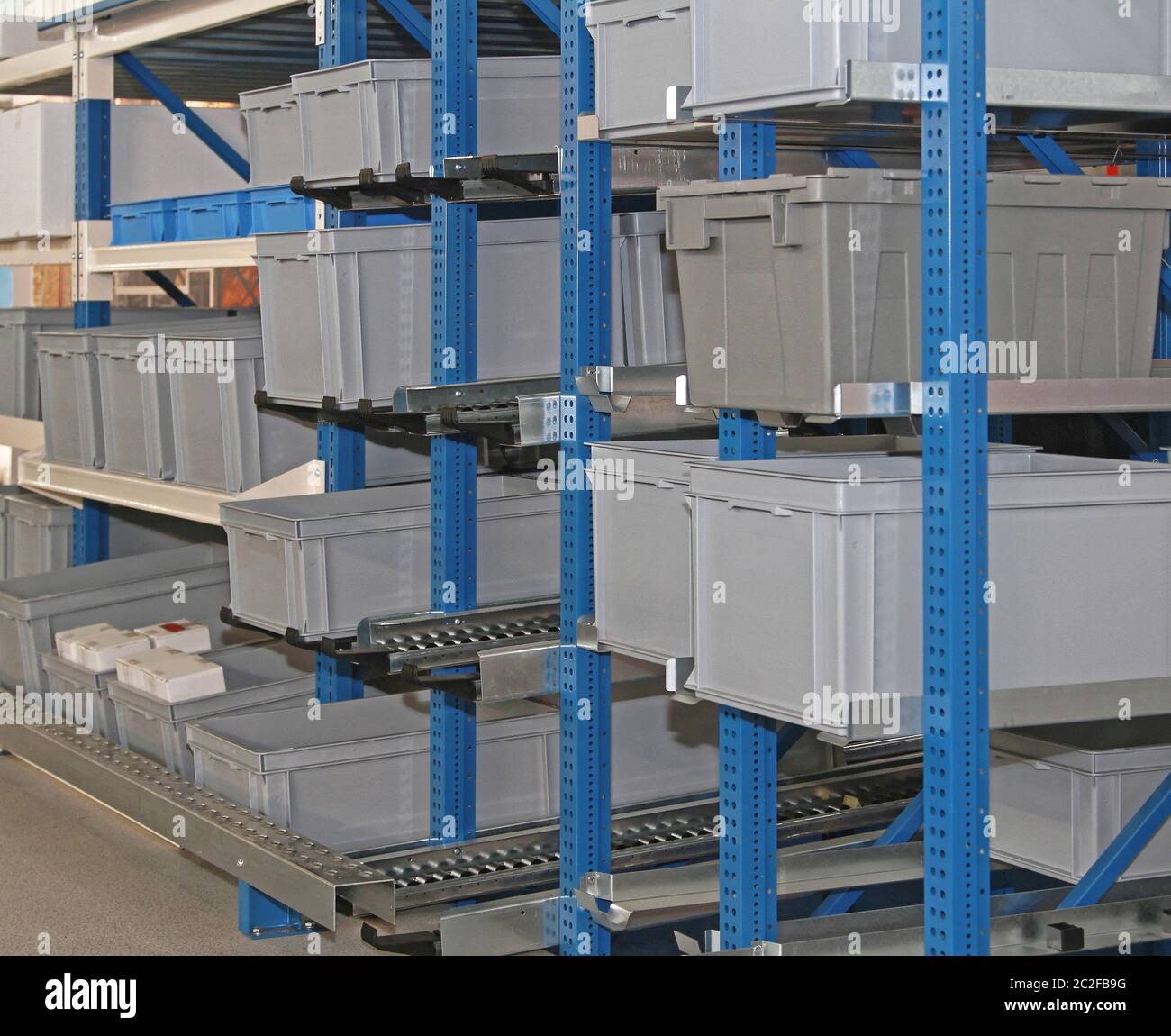 Plastic Crates and Boxes in Storage Room Shelf Stock Photo - Alamy