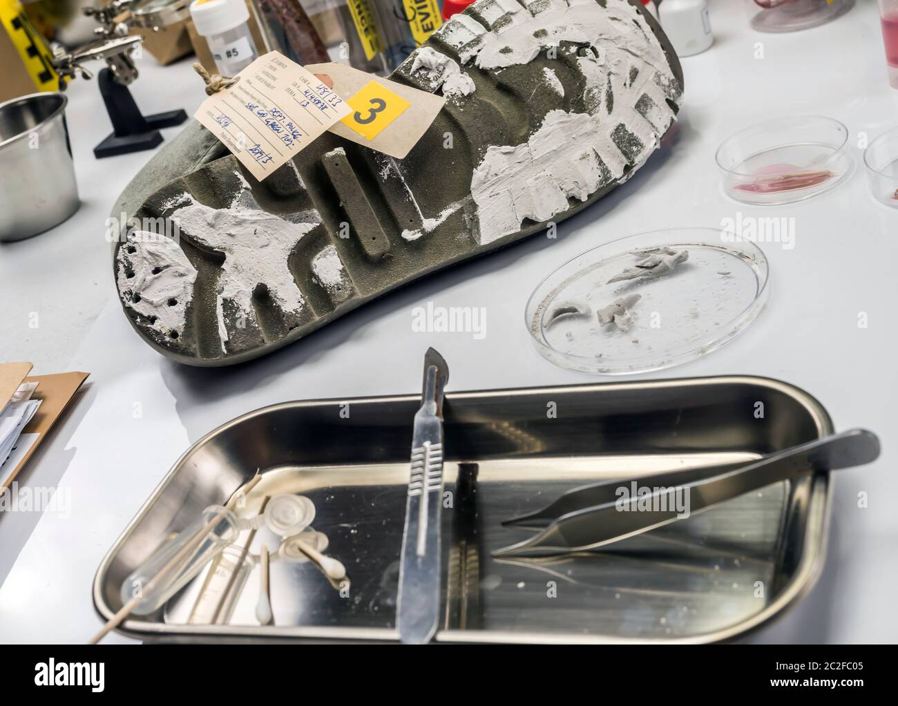 Shoe with cement footprints analyzed in crime lab, crime evidence ...