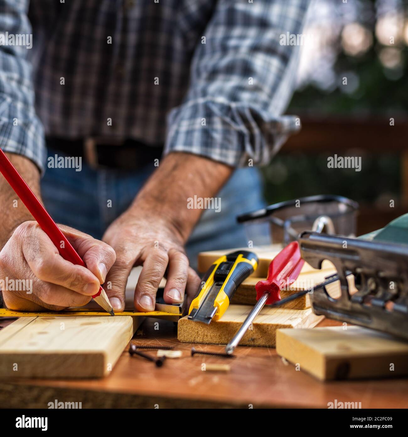 Adult carpenter craftsman with a pencil and the carpenter's square ...