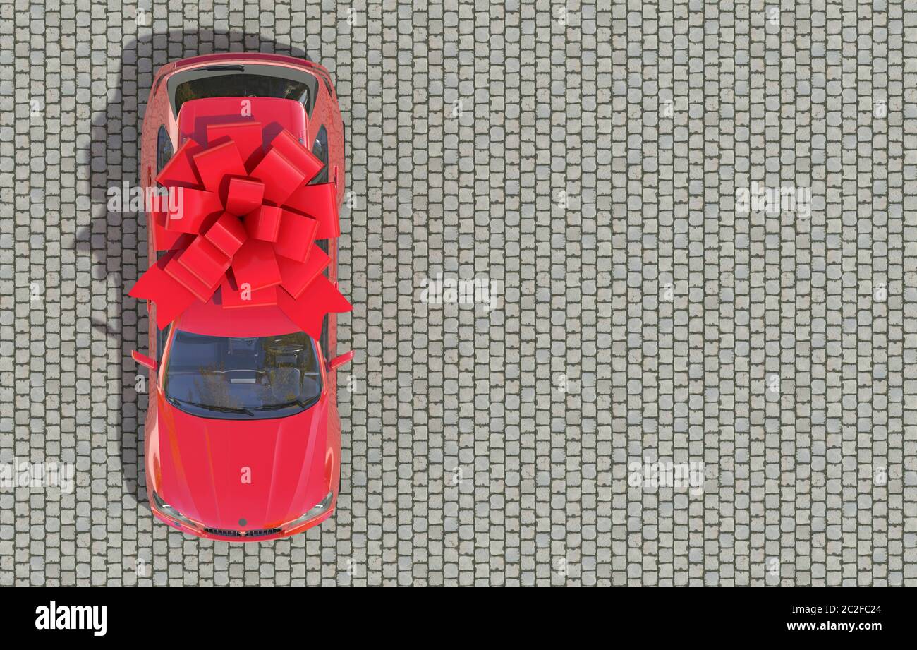 Red car wrapped in a red ribbon bow standing on the paving stones ...