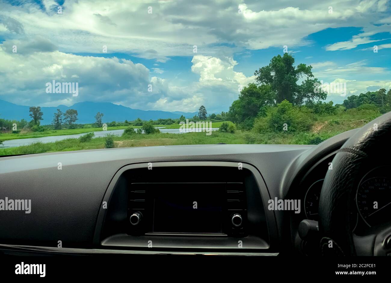 Beautiful landscape view from inside car. Steering wheel and dashboard ...