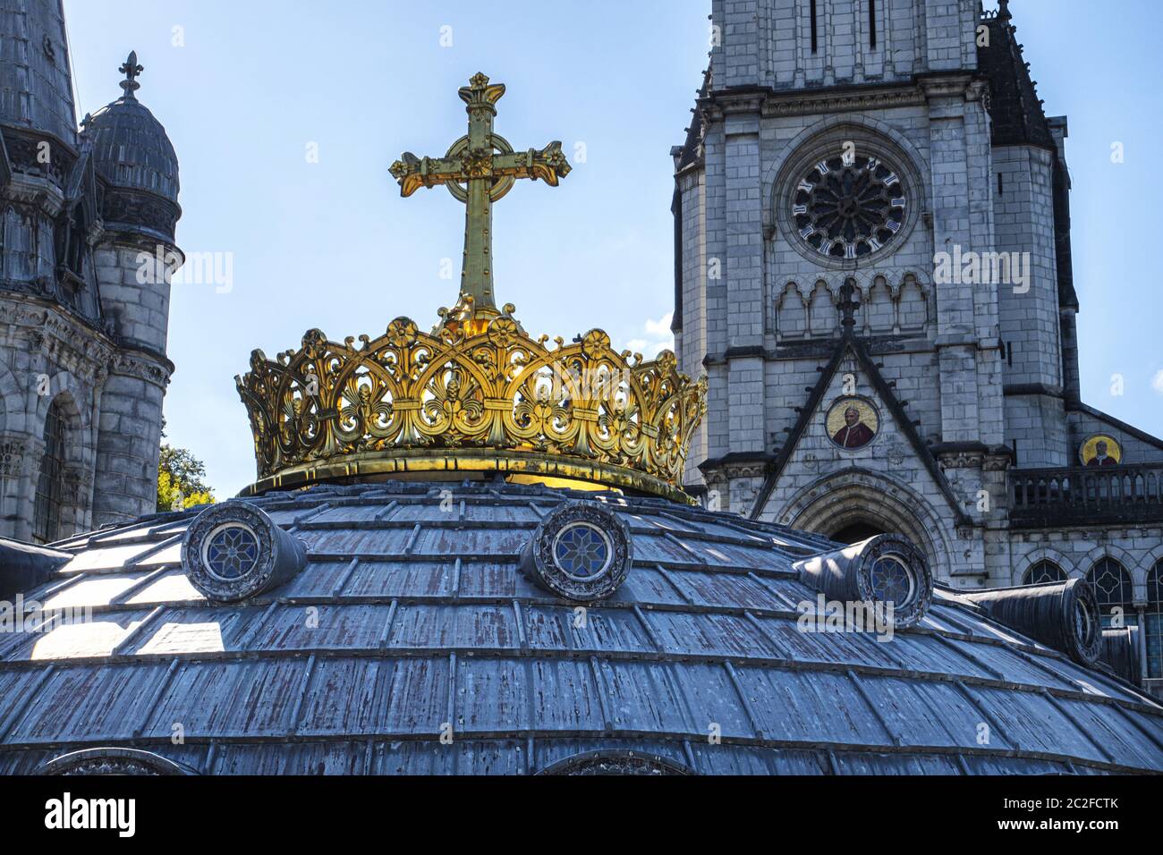The gilded crown ad cross in Lourdes city Stock Photo - Alamy