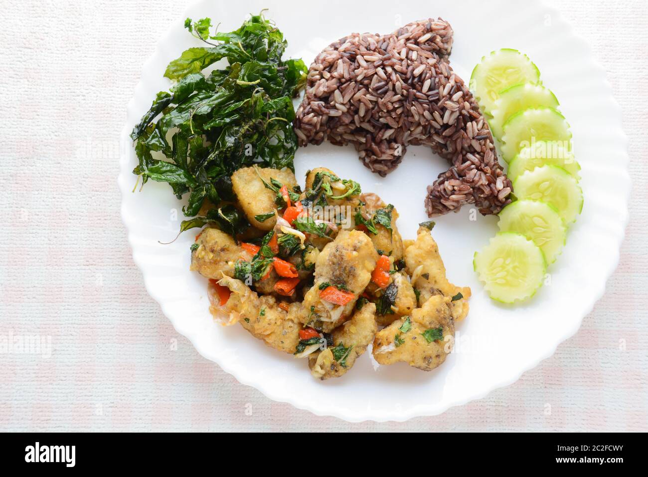 Stir fried fish with chili and basil, served with steamed rice and ...