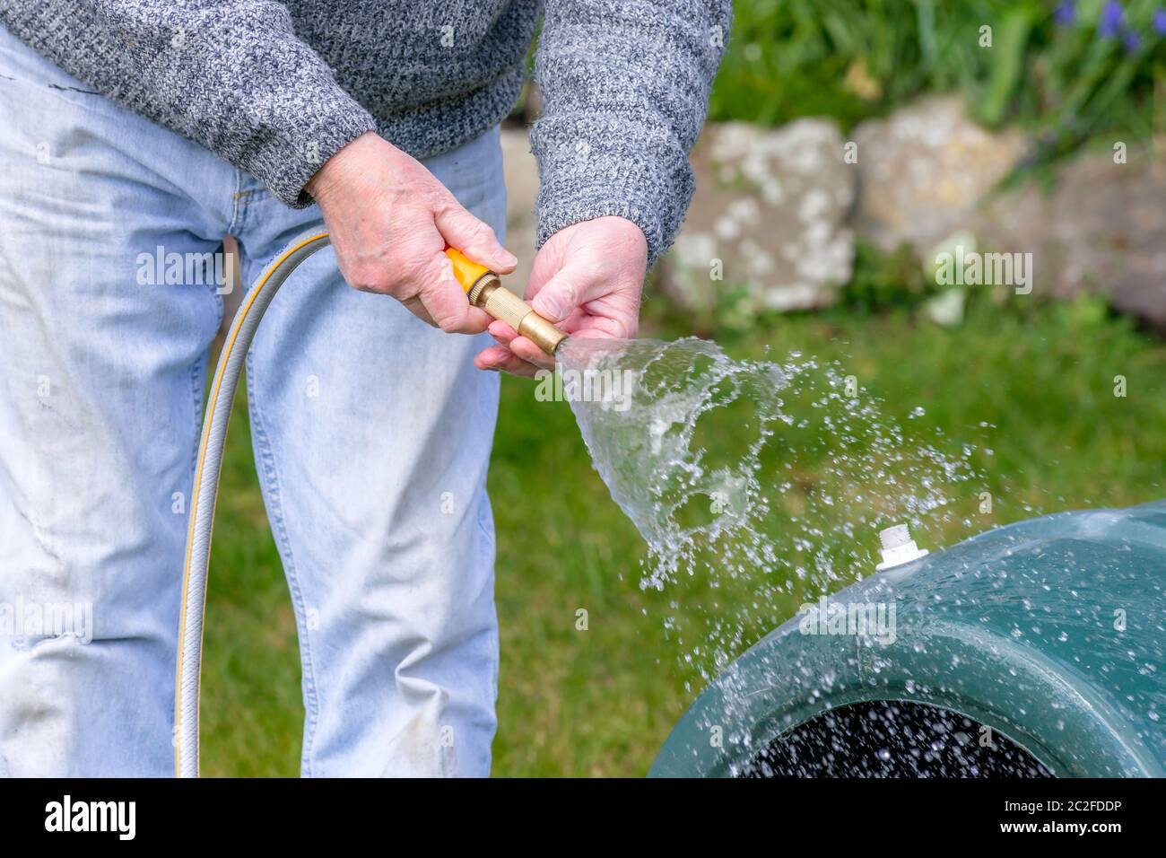 Man cleaning the butt with hose pipe Stock Photo - Alamy