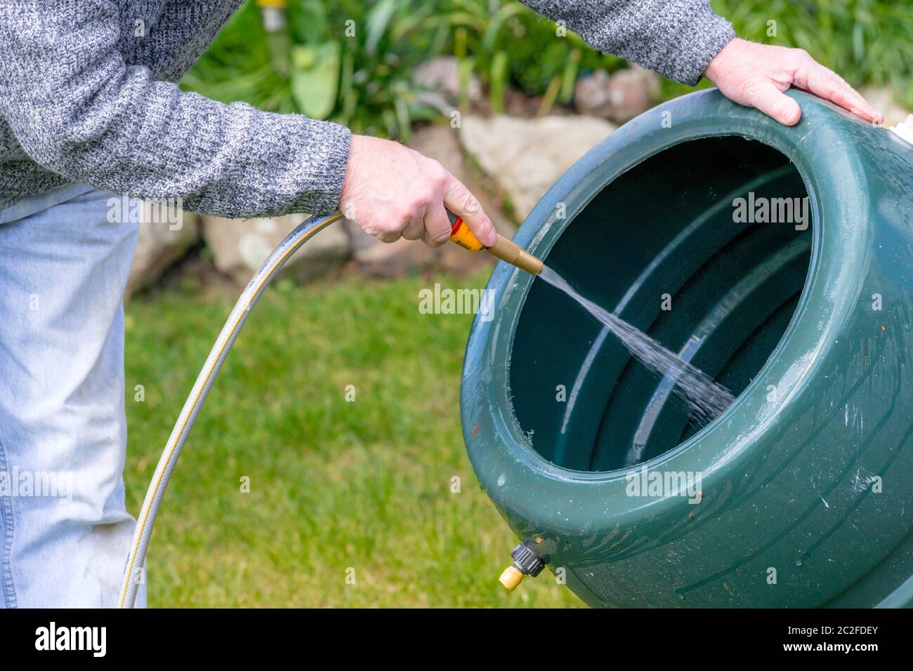 Man cleaning the butt with hose pipe Stock Photo - Alamy