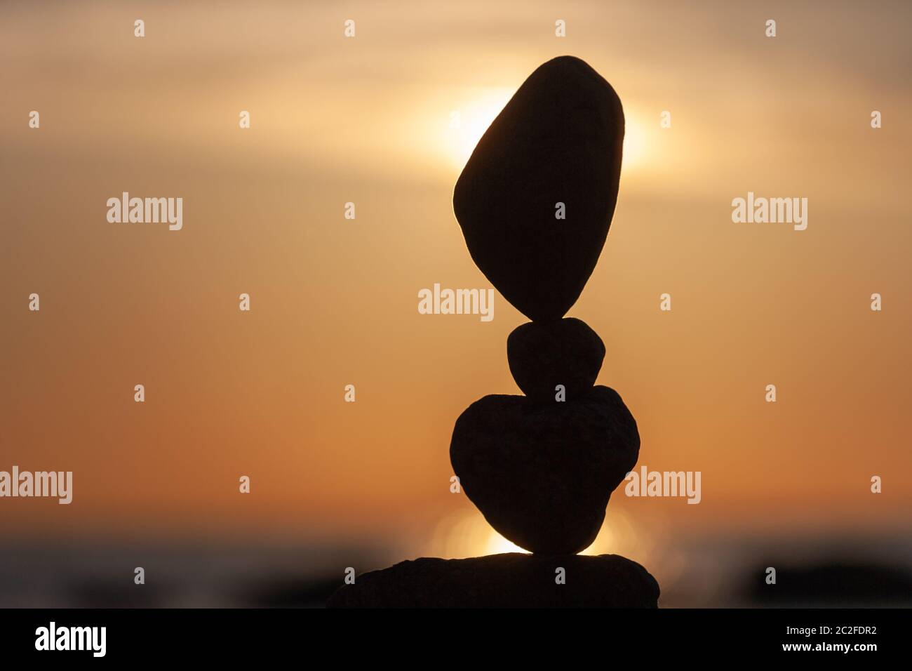 balanced stones on the beach at sunset Stock Photo - Alamy