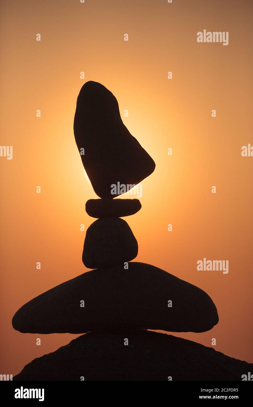 balanced stones on the beach at sunset Stock Photo - Alamy